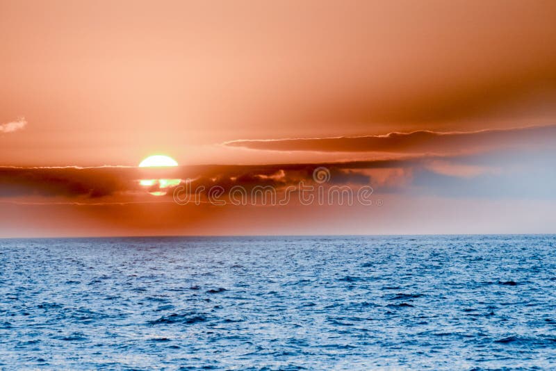 The Sun Setting in the Sea stock image. Image of time - 106381609