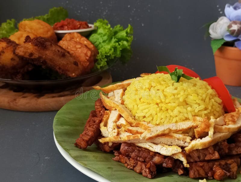 Photo of a Plate of Yellow Rice Complete with Side Dishes Stock Image ...