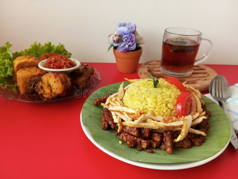 Photo of a Plate of Yellow Rice Complete with Side Dishes Stock Image ...