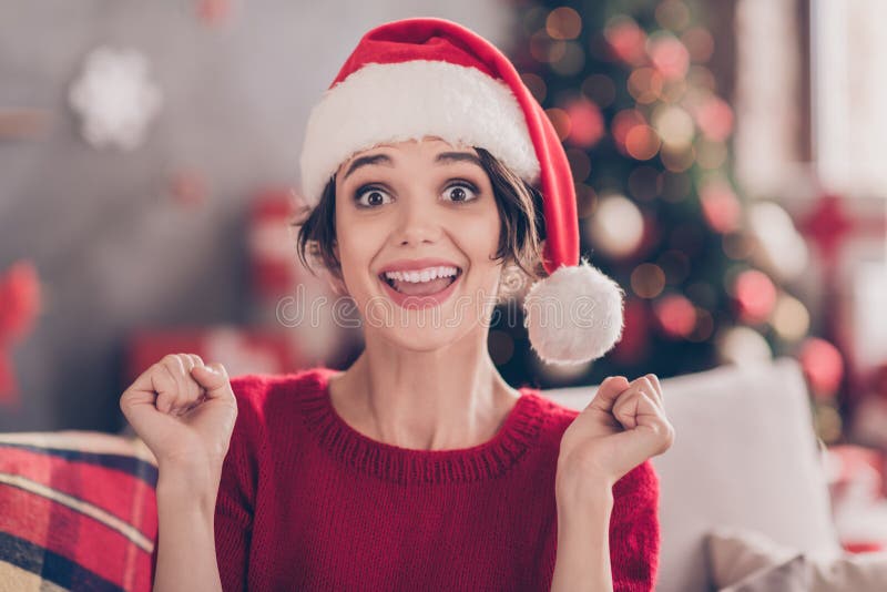 Photo Of Pretty Young Lady Raise Fists Wear Santa Headwear Red Pullover