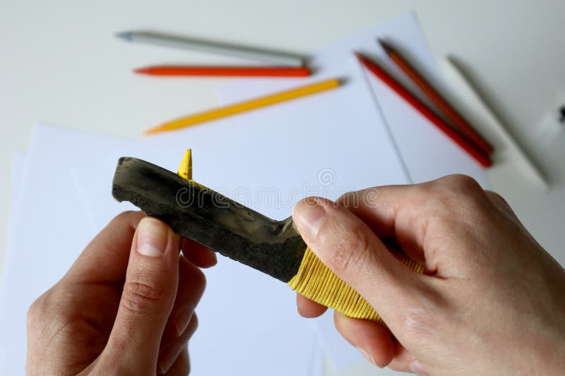 Photo of the Process of Sharpening Colored Pencils with a Clerical ...