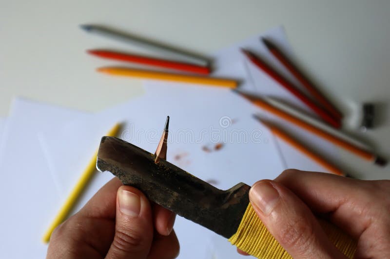 Photo of the Process of Sharpening Pencils with a Clerical Knife. Human ...
