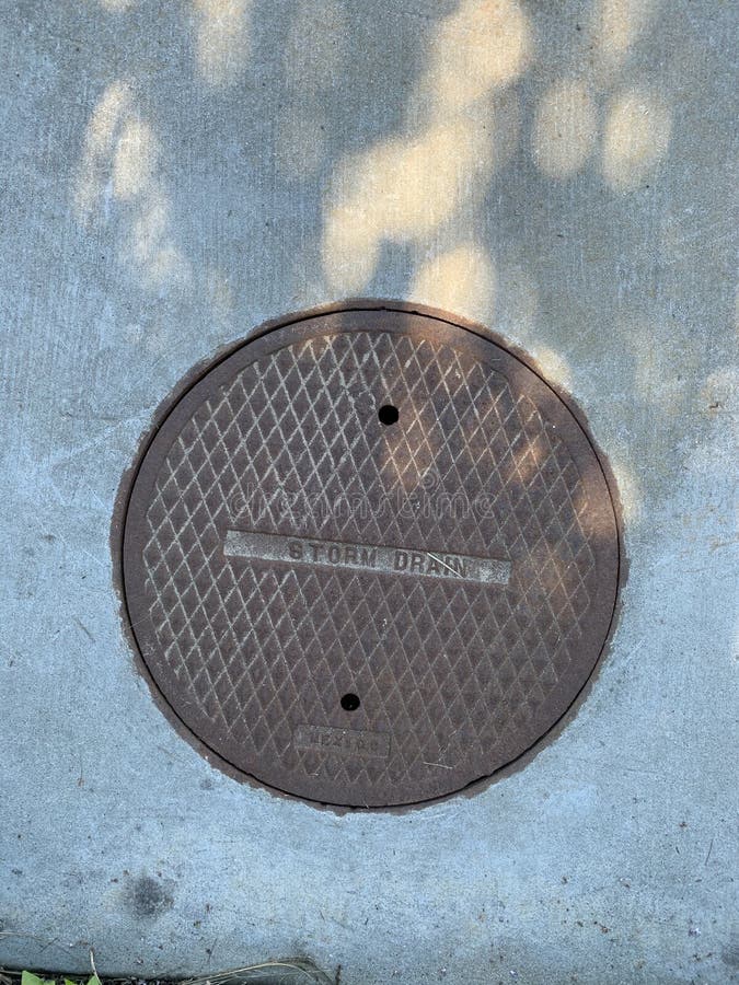 Storm Drain Cover stock image. Image of sidewalk, city - 353447971