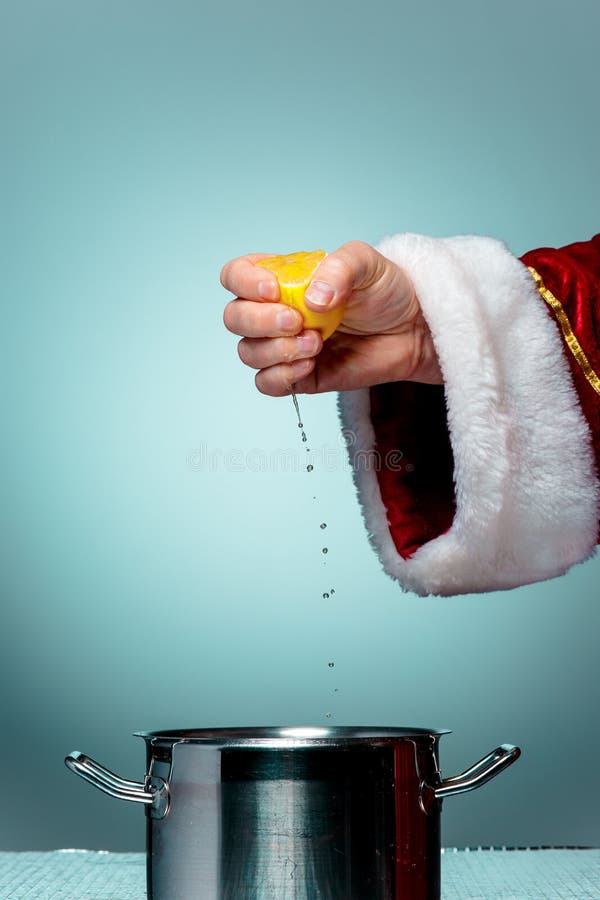 Photo of Santa Claus Hand Squeezing Lemon Stock Photo - Image of ...