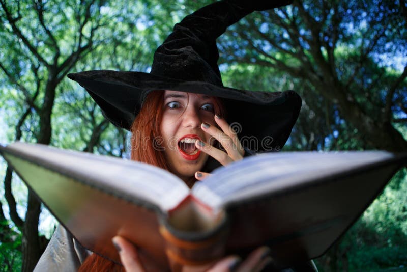 Photo of Witch with Open Magic Book Stock Photo - Image of cape ...
