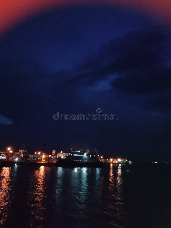 Photo of a Seascape at Night, with House Lights on Stock Photo - Image ...
