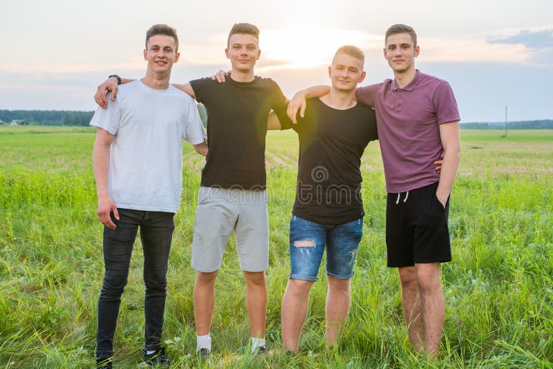 A Photo Session of a Group of Classmates Guys in a Field on a Summer ...