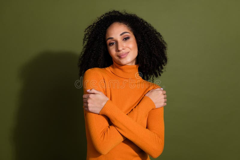 Photo of Shiny Attractive Lady Dressed Orage Pullover Hugging Herself ...