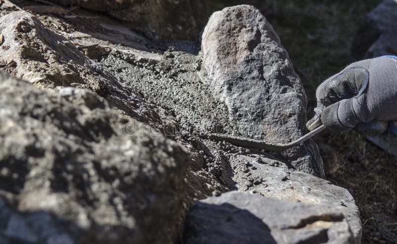 Working on a rock wall stock photo. Image of garden - 111657452