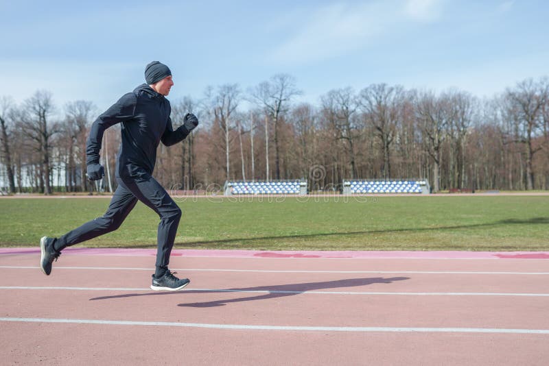 Photo on Side of Athlete Man Running through Stadium during Spring Jog ...