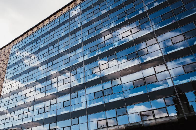 Photo of Sky Reflection on a Modern Building Facade Stock Photo - Image ...