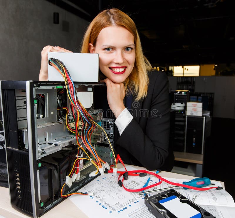 Photo of Smiling Woman at Table Next To Broken Processor Stock Photo ...