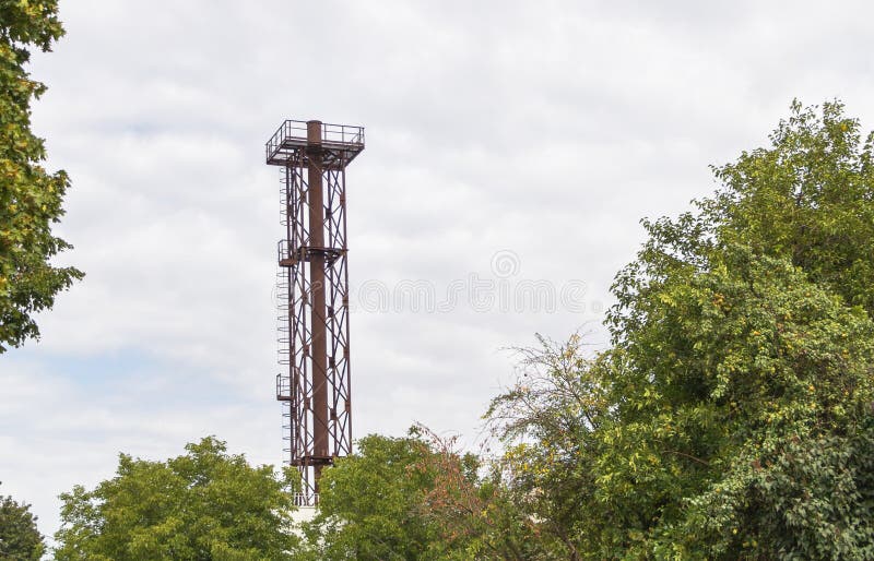 A Photo of a Tall Industrial Metal Tower with a Rusty Texture, Visible ...