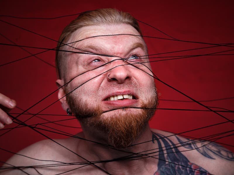 Tangled in Black Threads Bearded Man on Red Background Stock Photo ...