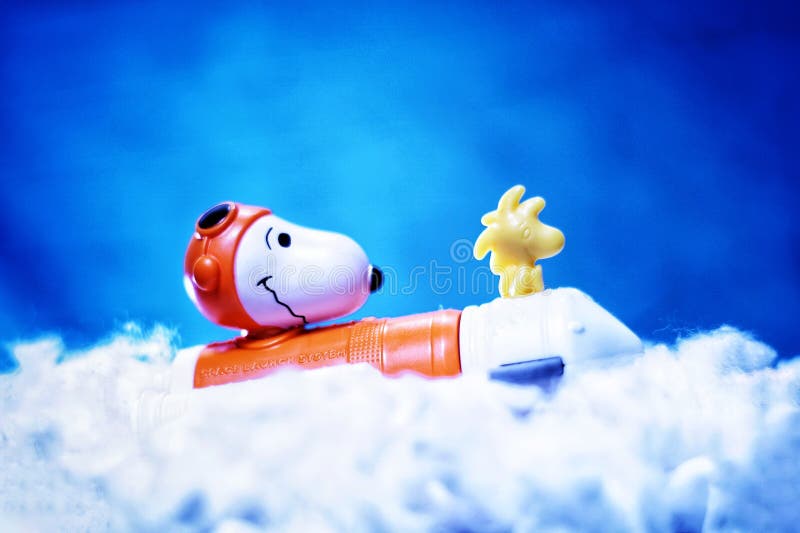 Photo of Toy Snoopy Flying through the Clouds Stock Photo - Image of ...