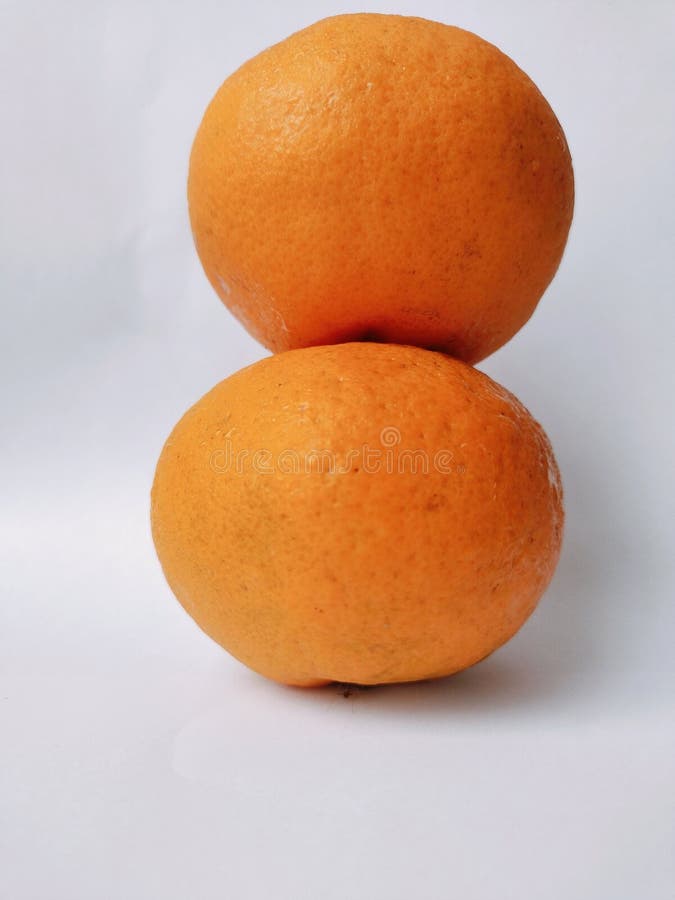 Photo of Two Oranges Stacked Together so they are Tall on a White ...