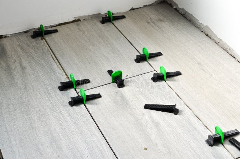 Photo of Using Plastic Clamps and Wedges To Leveling the Large Ceramic ...