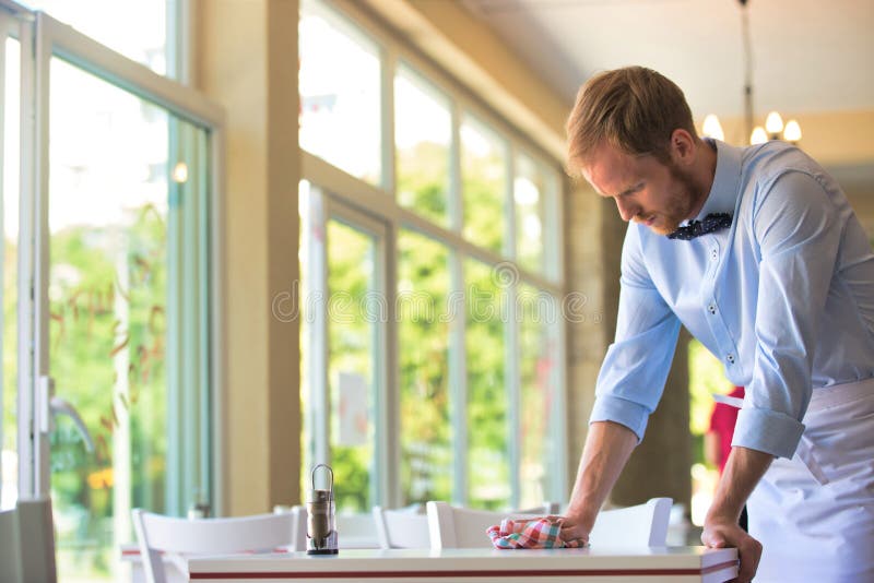 Waiter Cleaning the Table at Restaurant Stock Photo - Image of serving ...