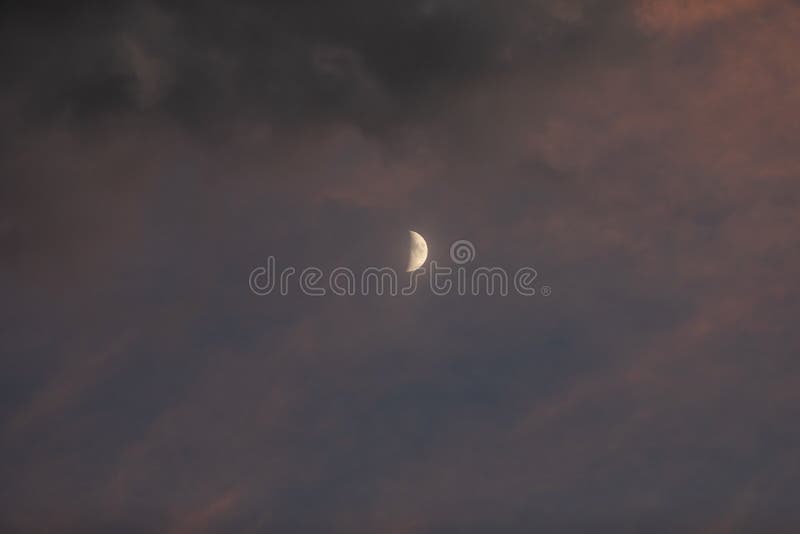 Photo of a Waxing Crescent Half Moon in the Clouds Stock Photo - Image ...