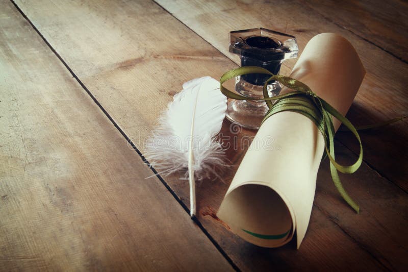 Photo of White Feather and Inkwell on Old Wooden Table Stock Image ...