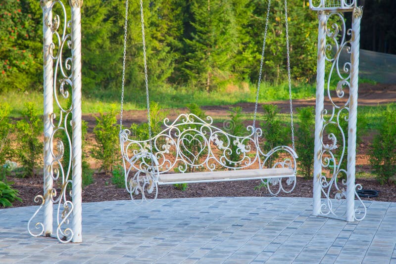 White Swing in a Green Park. White Wooden Swing Outdoor Stock Image ...