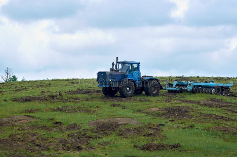 Photo of Working Tractor on the Field Editorial Photo - Image of ...