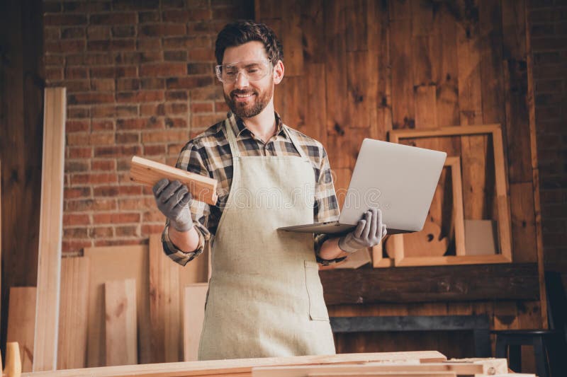 Photo of Workman Guy Hold Laptop Look Plank Timber in Workshop Garage ...