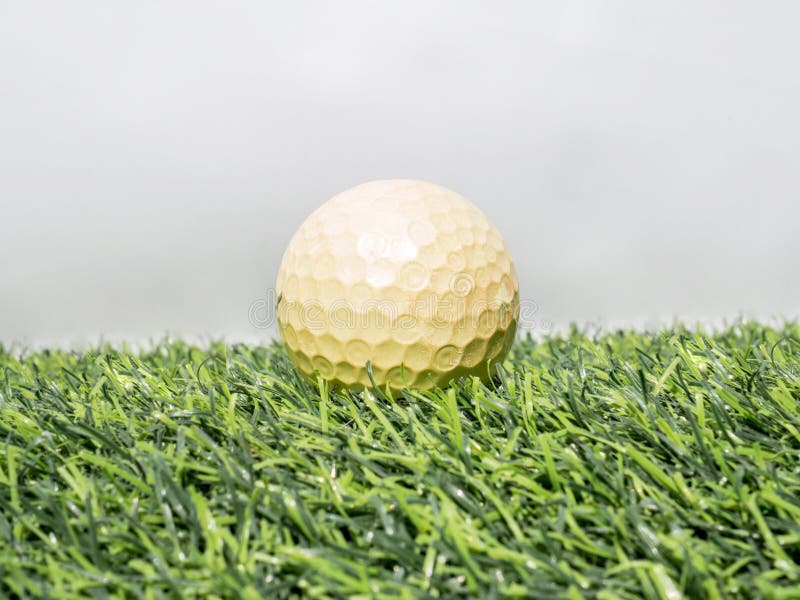 Photo of Yellow Golf Ball on Artificial Grass with White Background ...