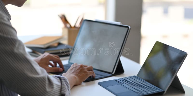 Photo of Young Businessman Typing on Computer Tablet with Keyboard Case ...