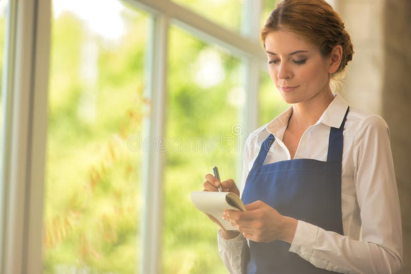 Young Confident Waitress Writing on Notepad at Restaurant Stock Image ...