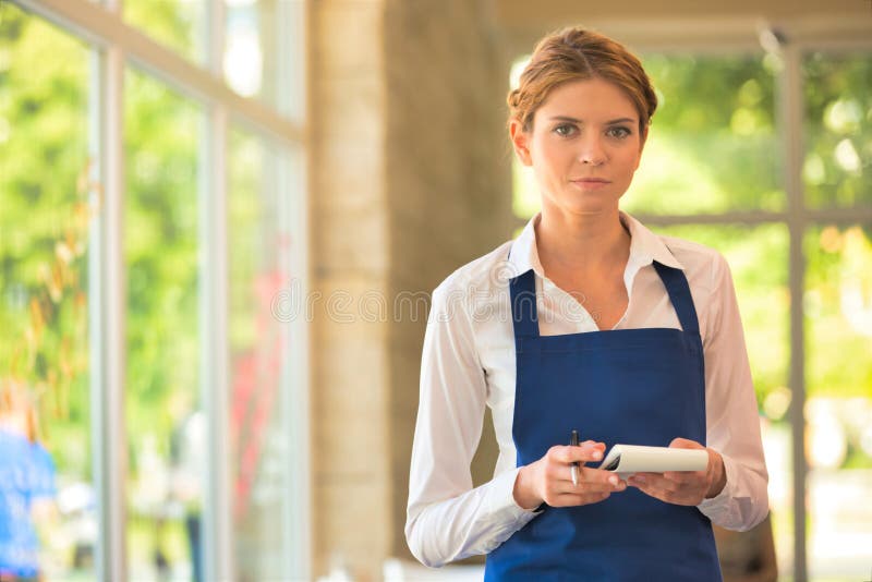 Young Confident Waitress Writing on Notepad at Restaurant Stock Image ...