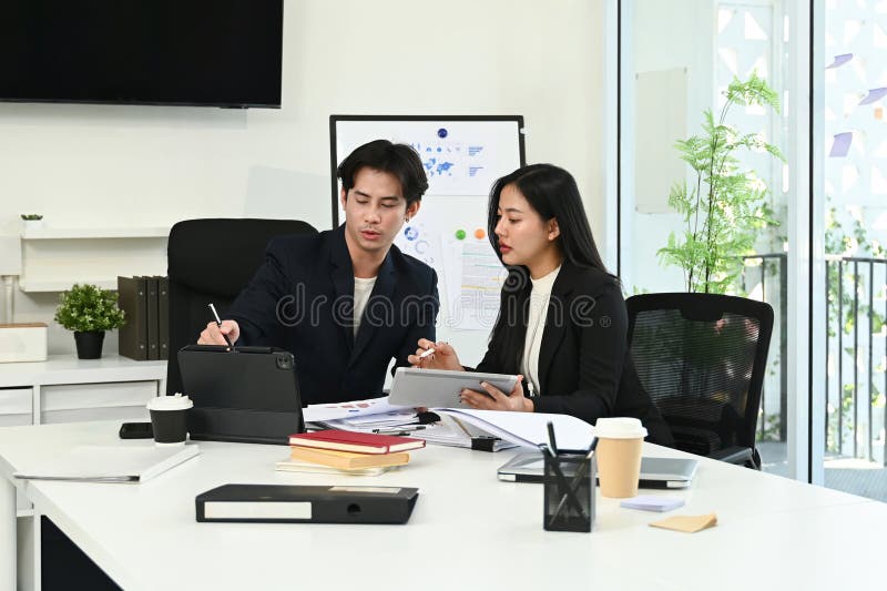 Photo of Young Office Workers Working Together at the Working Desk with ...