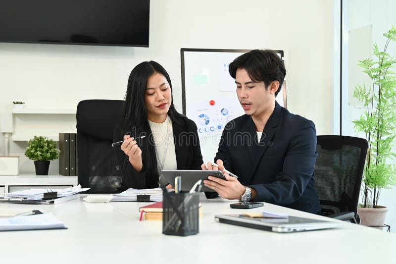 Photo of Young Office Workers Working Together at the Working Desk with ...