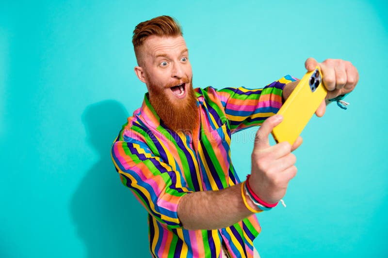 Photo Of Young Overjoyed Irish Man Cant Stop Playing Mobile Games Addicted Holding Smartphone 2419