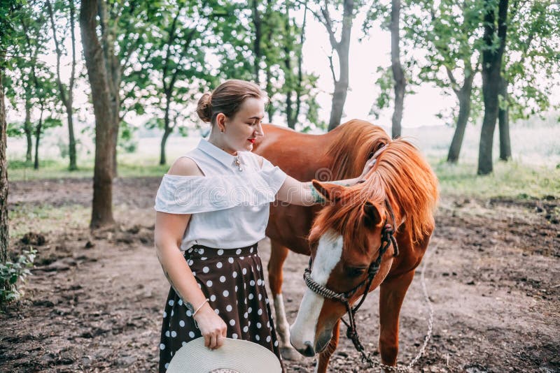 Photo of a Young Smiling Blonde, in a White Blouse and Skirt, with a ... Photo of a Young Smiling Blonde, in a White Blouse and Skirt, with a ...