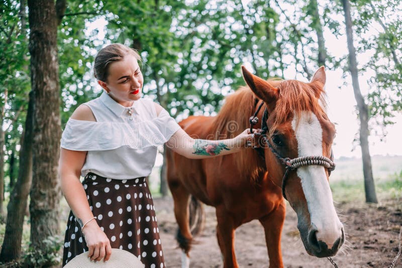 Photo of a Young Smiling Blonde, in a White Blouse and Skirt, with a ... Photo of a Young Smiling Blonde, in a White Blouse and Skirt, with a ...