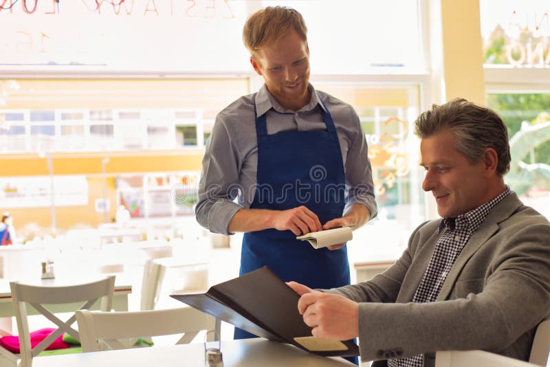 Young Waiter Taking Orders from Customer at Restaurant Stock Image ...