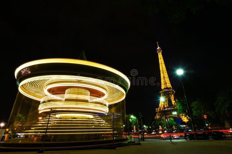 Night View of the Eiffel Tower and the Spinning Carousel Nearby in Long ...