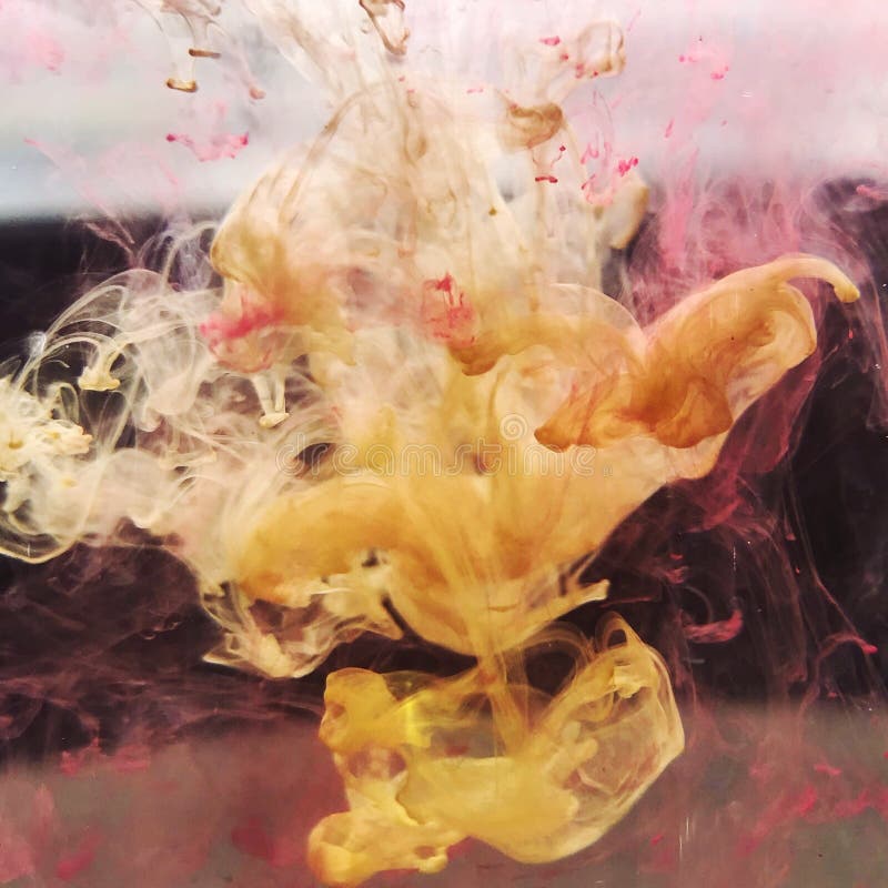 Yellow ink drops in water stock image. Image of dispersion - 141799495