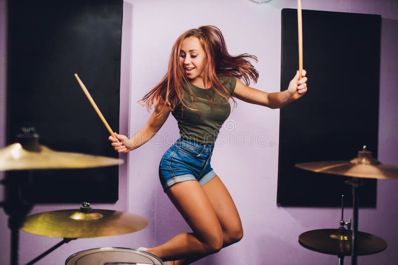 Photograph Of A Female Drummer Playing A Drum Set On Stage Stock Image