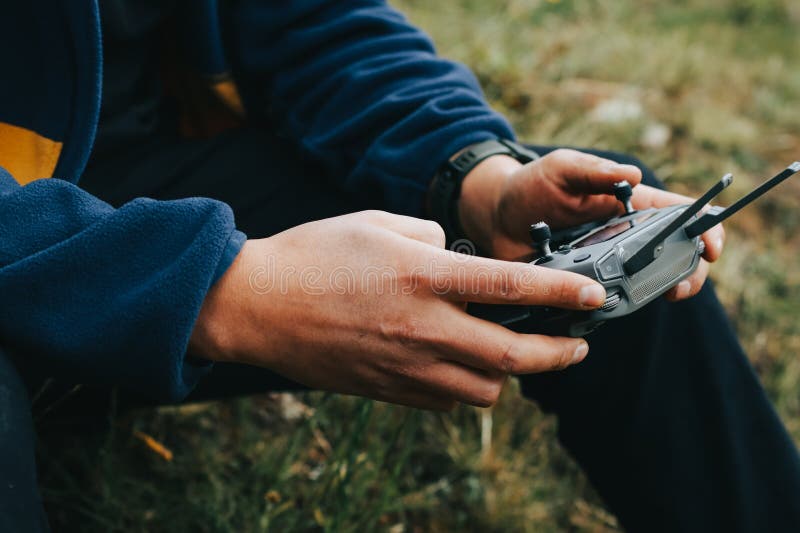 Man S Hands Holding the Remote Control of a Drone (Drone Operator ...
