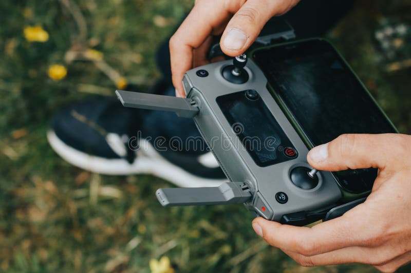 Man S Hands Holding the Remote Control of a Drone (Drone Operator ...