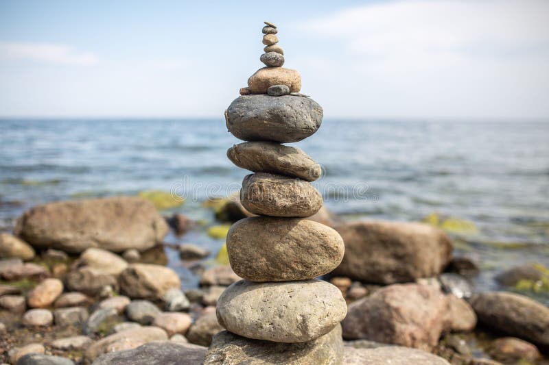 A Stack of Balanced Stones on a Rocky Beach with the Ocean in the ...