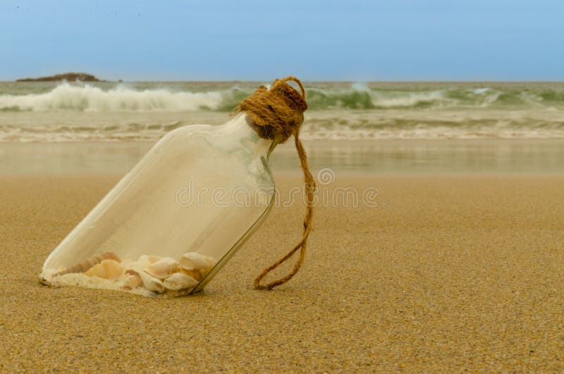 Bottle on the Beach, Full of Shells, Conch and Sand Stock Photo - Image ...