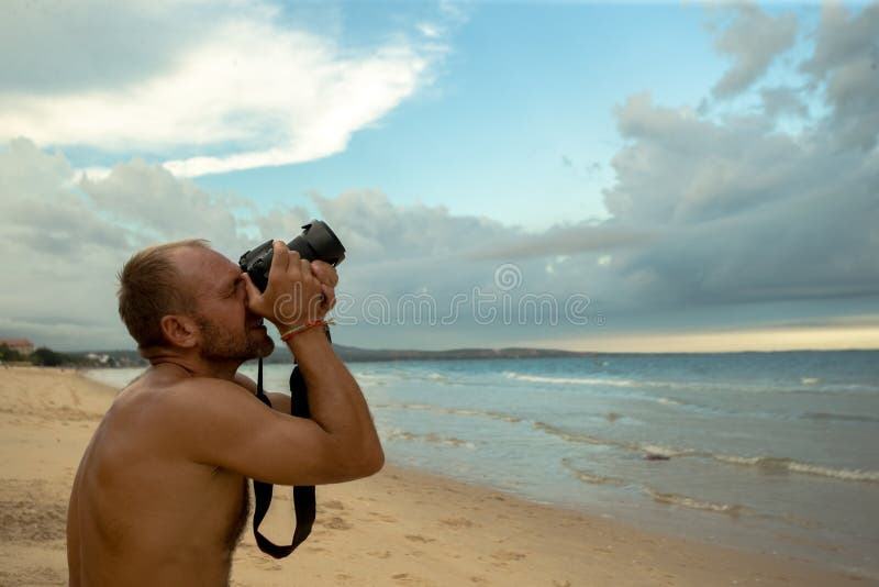 Photographer on the beach stock photo. Image of photograph - 76509778