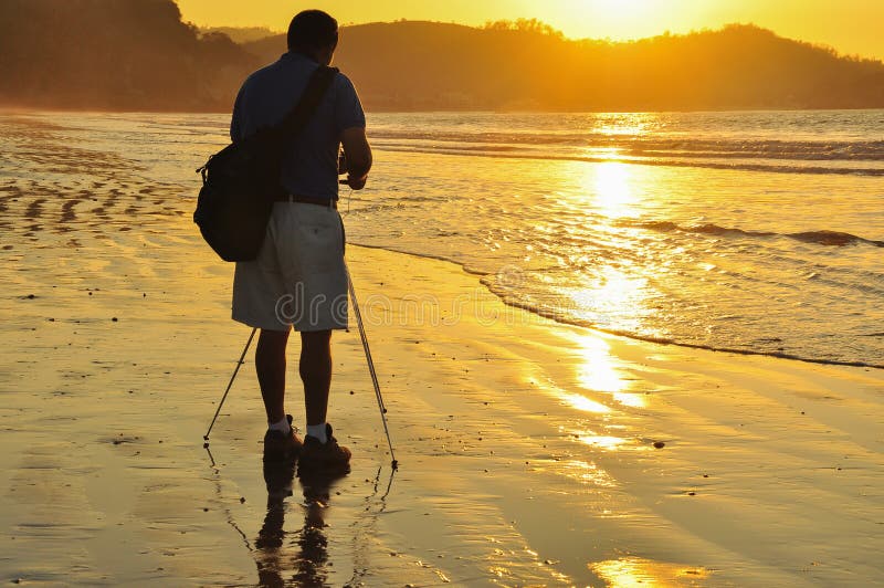 A Photographer on the Beach at Sunset Stock Photo - Image of water ...