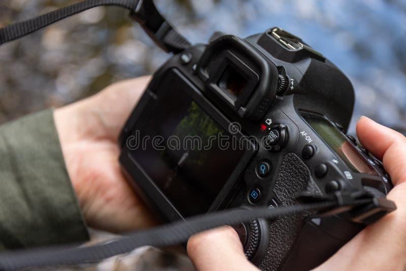 Photographer Check an Image on the Rear Viewfinder of a Camera Stock ...