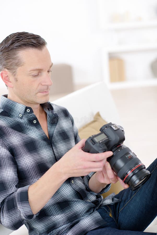 Photographer Checking Camera Indoors Stock Photo - Image of digital ...