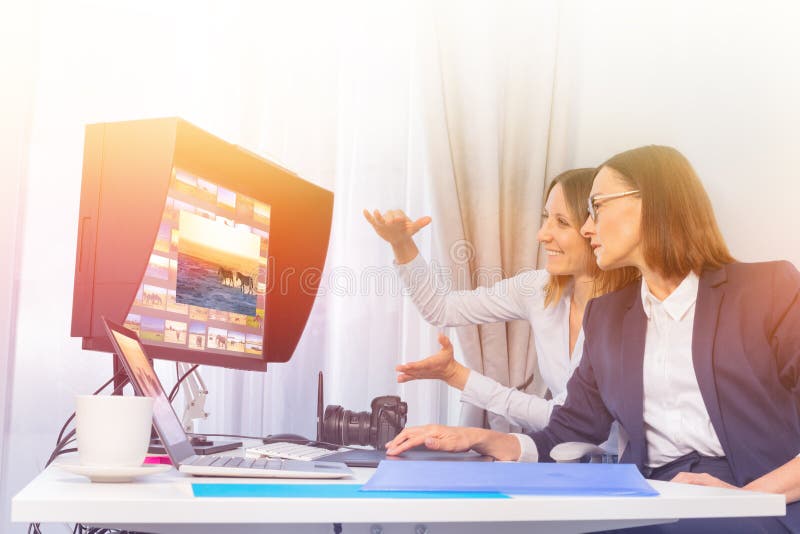 Photographer and Client Editing Photos in Office Stock Photo - Image of ...