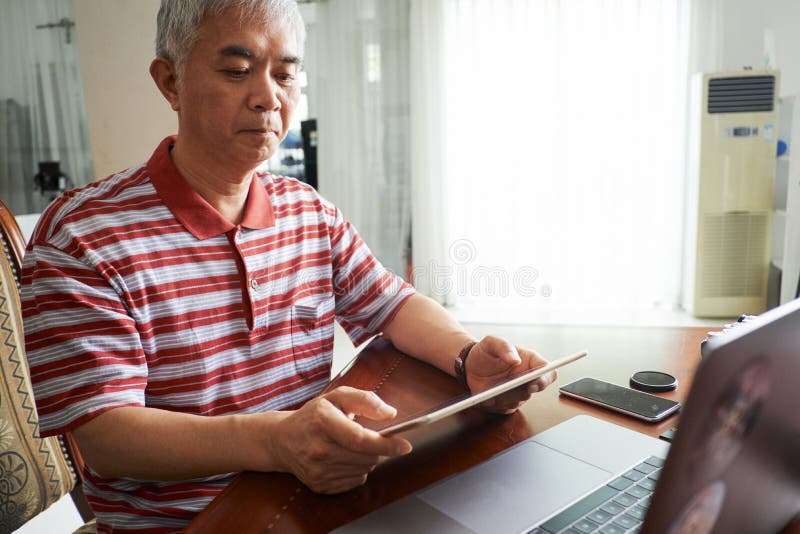 Photographer Looking at Photos on Tablet Stock Image - Image of asian ...